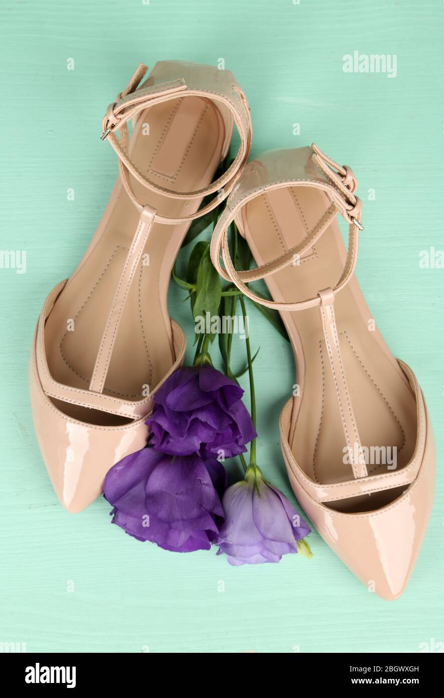 Beautiful woman shoes with flowers on wooden background Stock Photo - Alamy
