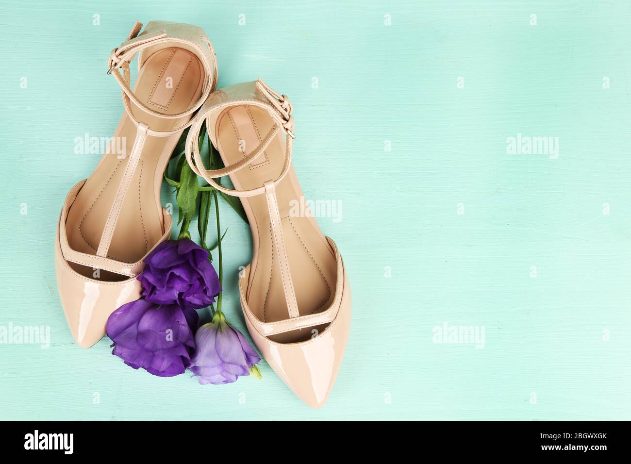Beautiful woman shoes with flowers on wooden background Stock Photo - Alamy
