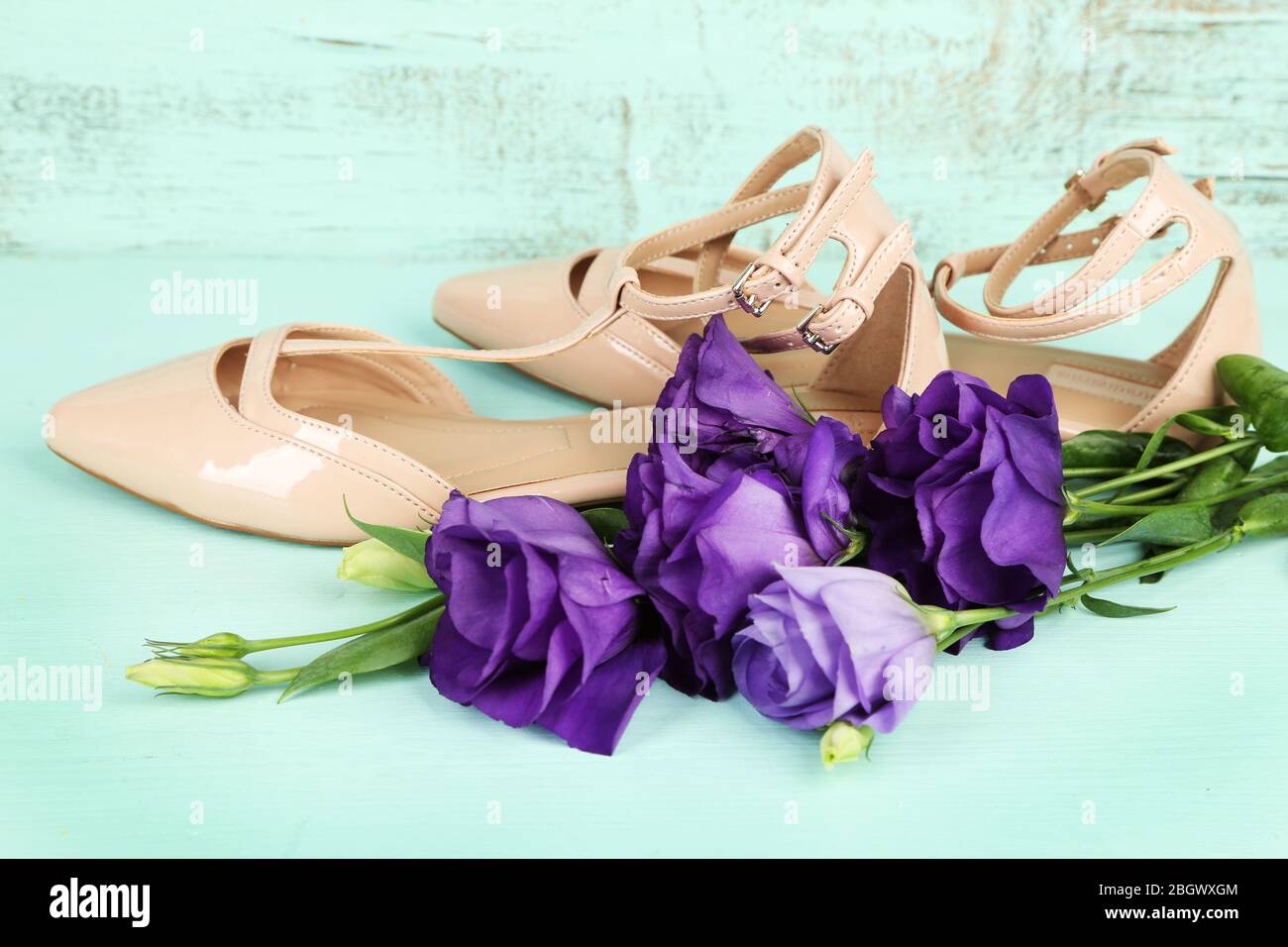 Beautiful woman shoes with flowers on wooden background Stock Photo - Alamy