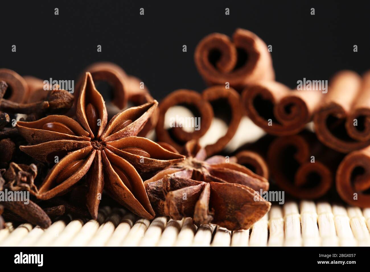 Carnation with cinnamon sticks and star anise on dark background Stock ...