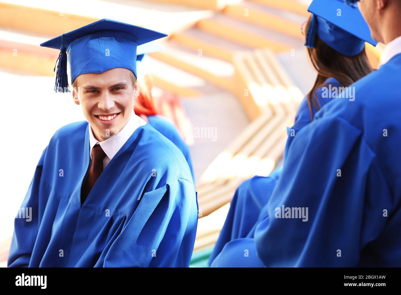 Graduate students wearing graduation hat and gown, outdoors Stock Photo ...