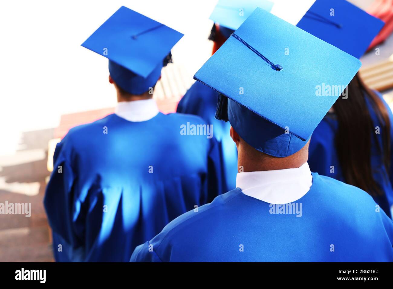 Graduate students wearing graduation hat and gown, outdoors Stock Photo ...