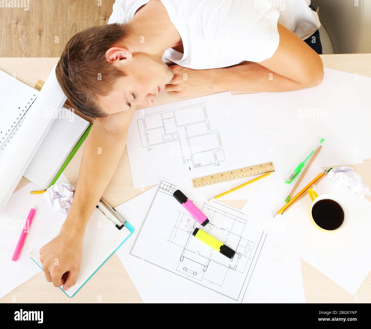 Tired man sleeping on table Stock Photo - Alamy
