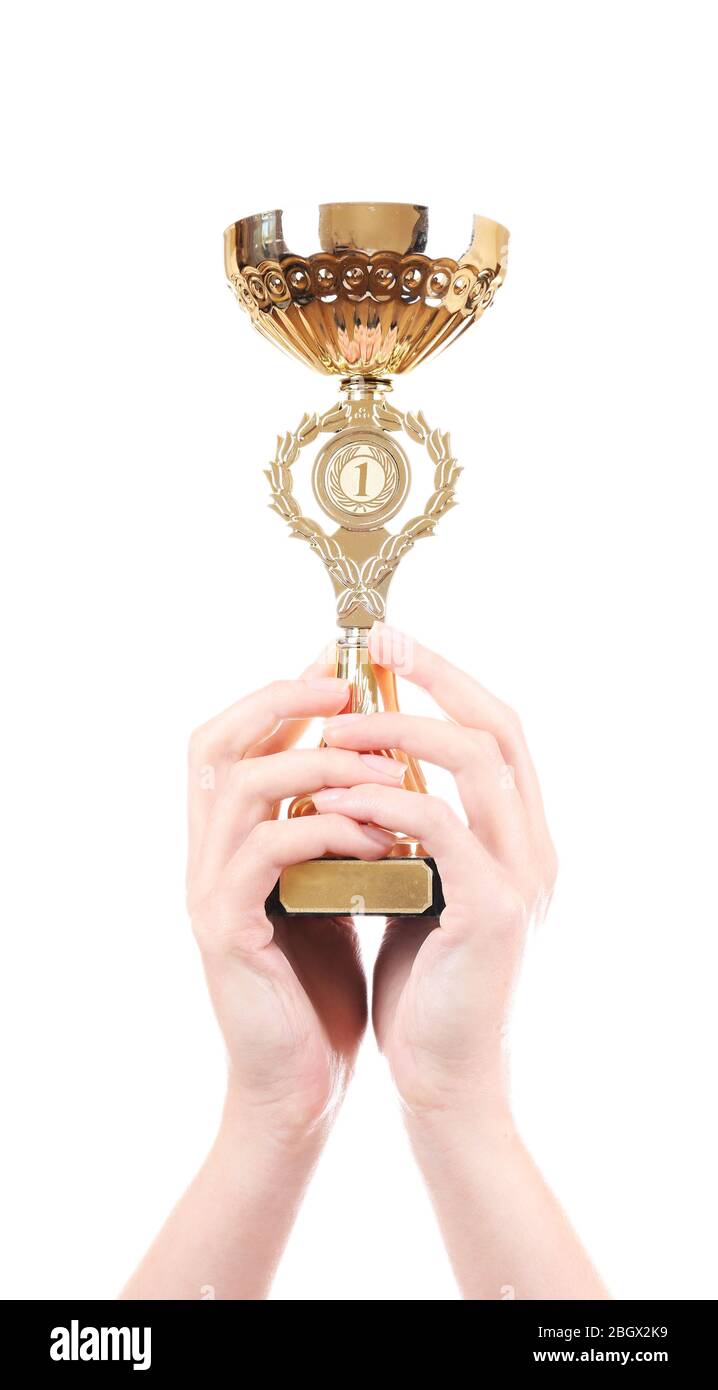 Gold cup in hand isolated on white Stock Photo - Alamy