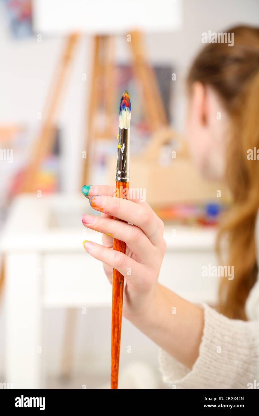 Artist holding paintbrush in art studio Stock Photo - Alamy