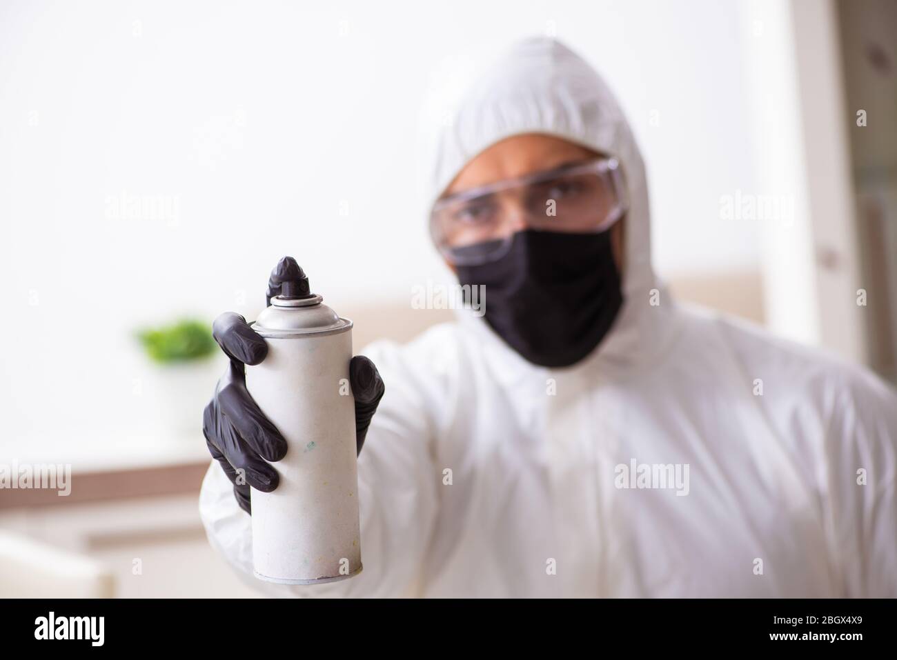 Young male contractor doing pest control Stock Photo - Alamy