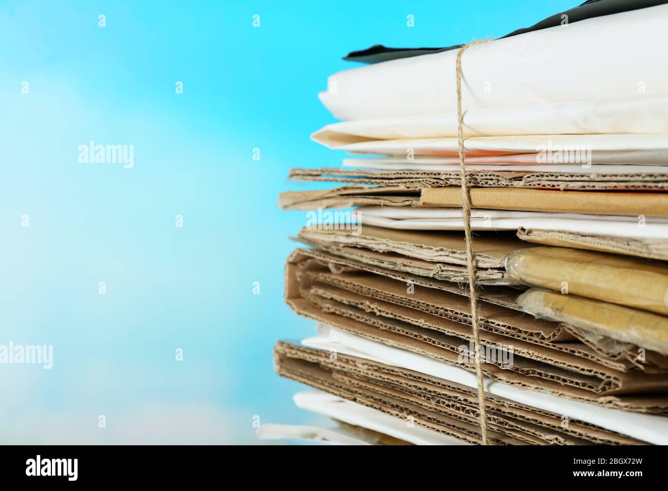 Big stack of papers on blue background, close-up Stock Photo - Alamy