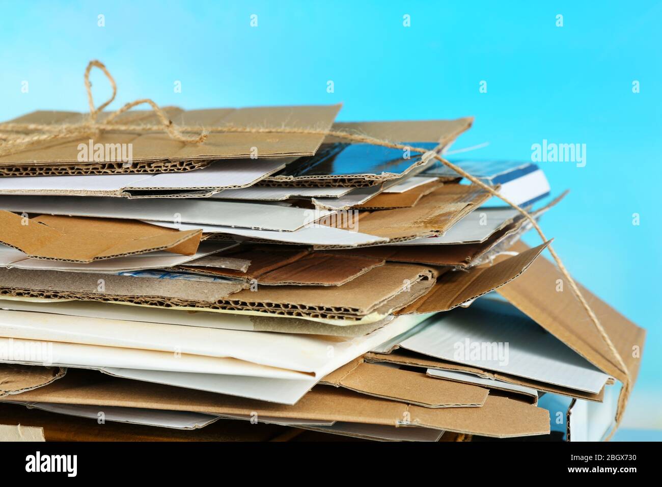 Big stack of papers on blue background, close-up Stock Photo - Alamy