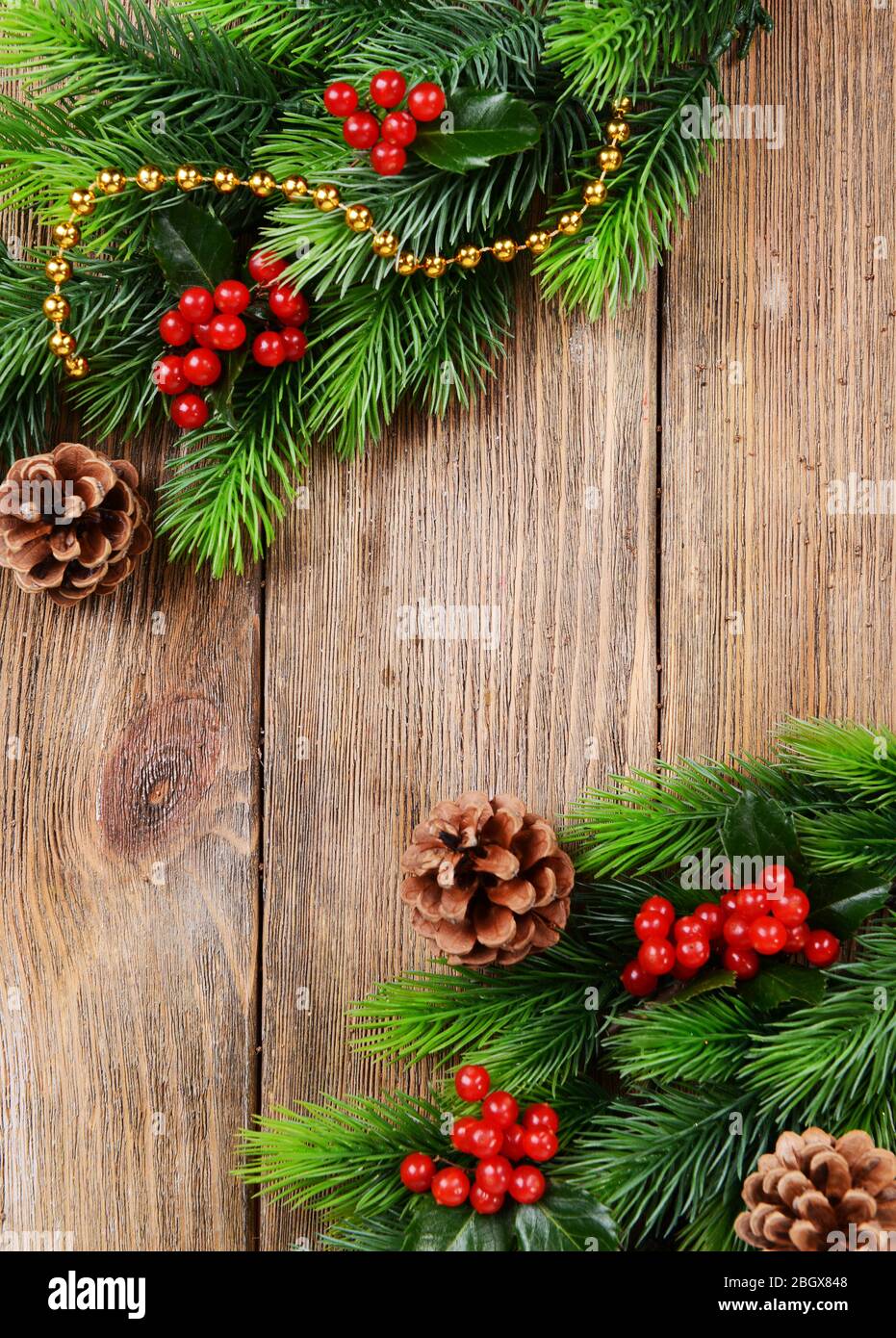 Beautiful Christmas border from fir and mistletoe on wooden background ...