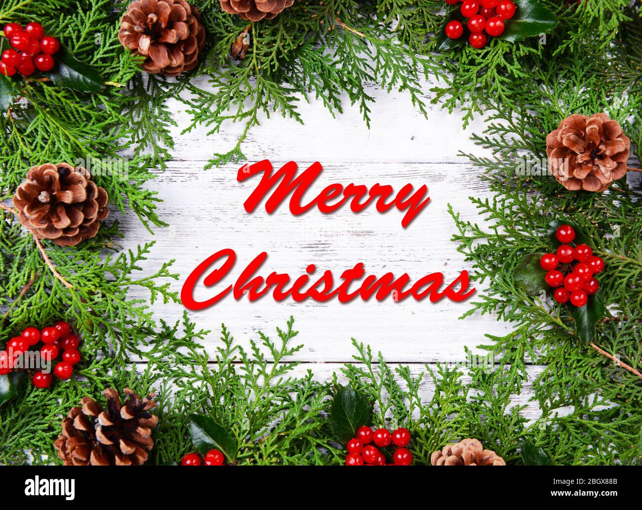 Beautiful Christmas border from fir and mistletoe on wooden background ...