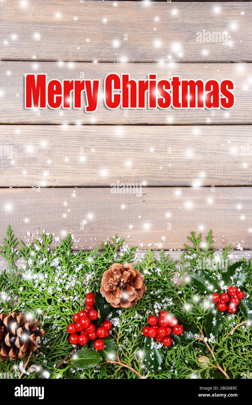 Beautiful Christmas border from fir and mistletoe on wooden background ...