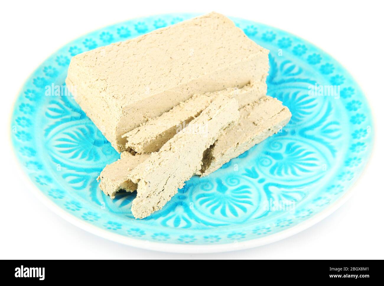 Sunflower halva on plate isolated on white background Stock Photo - Alamy