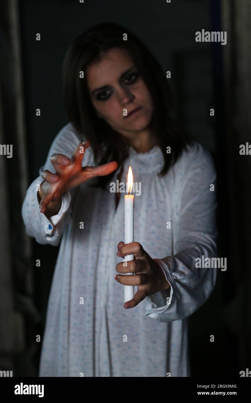 Horror Scene of with scary woman with candle Stock Photo - Alamy