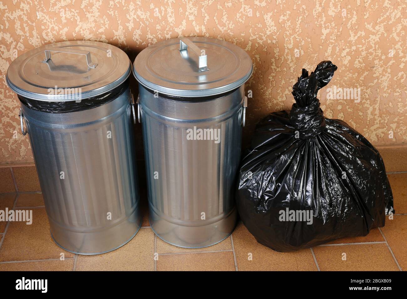 Recycling bins on wall background Stock Photo - Alamy