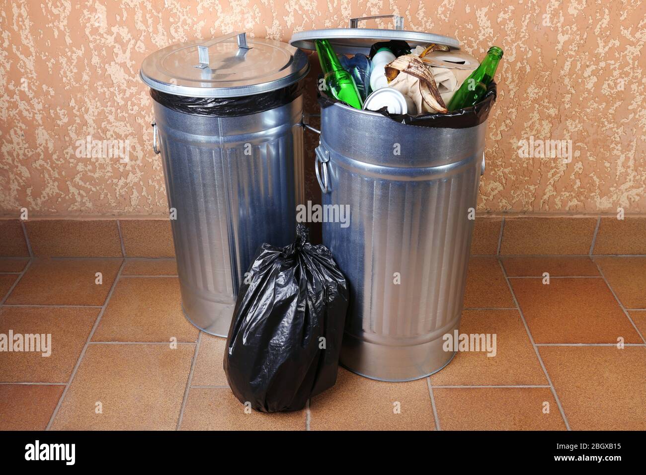 Recycling bins on wall background Stock Photo - Alamy
