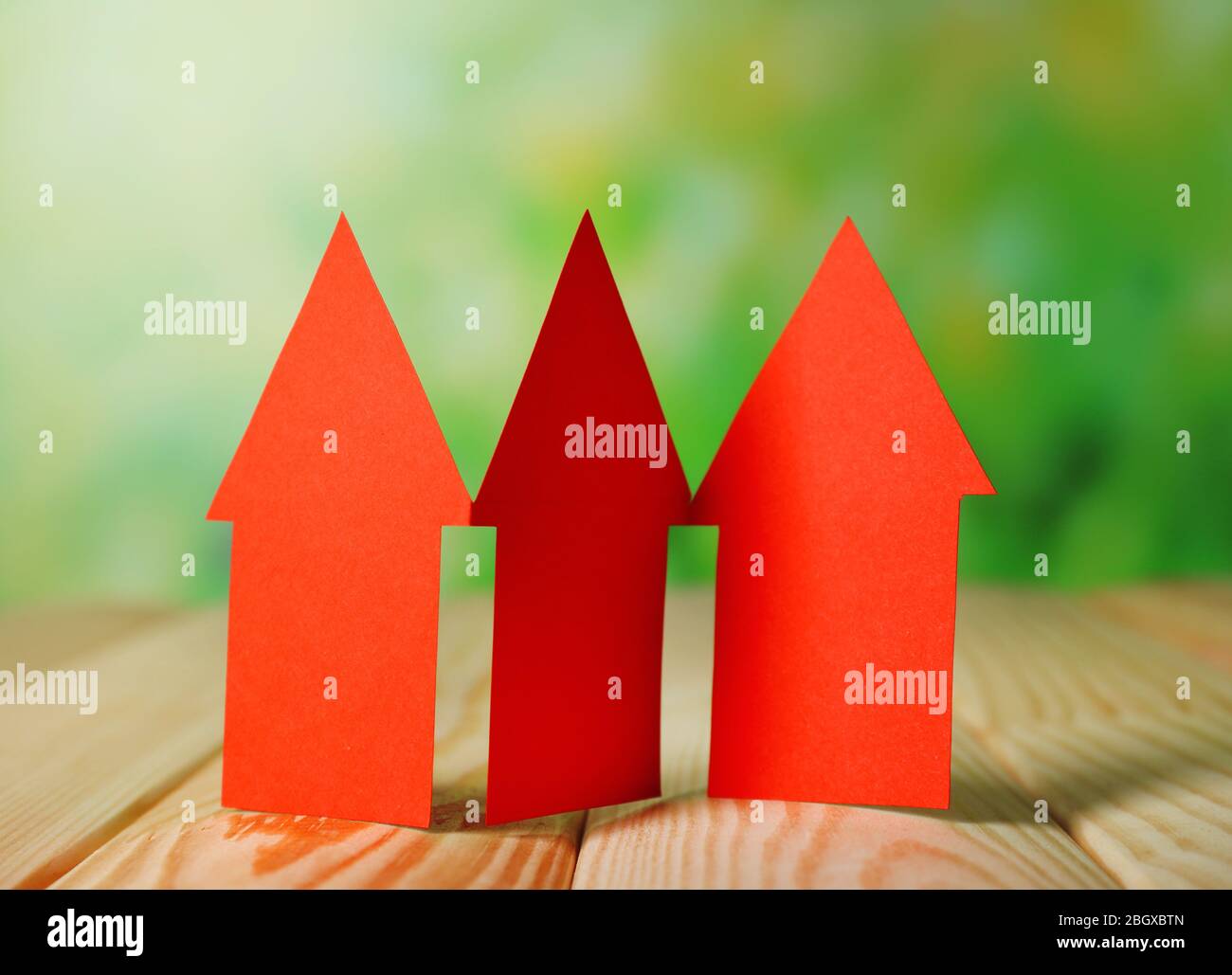 Paper houses on table on natural background Stock Photo - Alamy