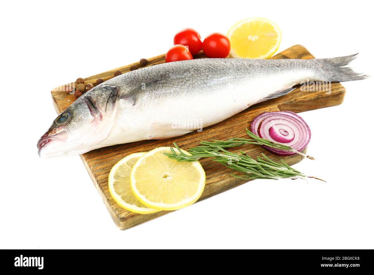 Fresh raw fish on cutting board and food ingredients isolated on white ...