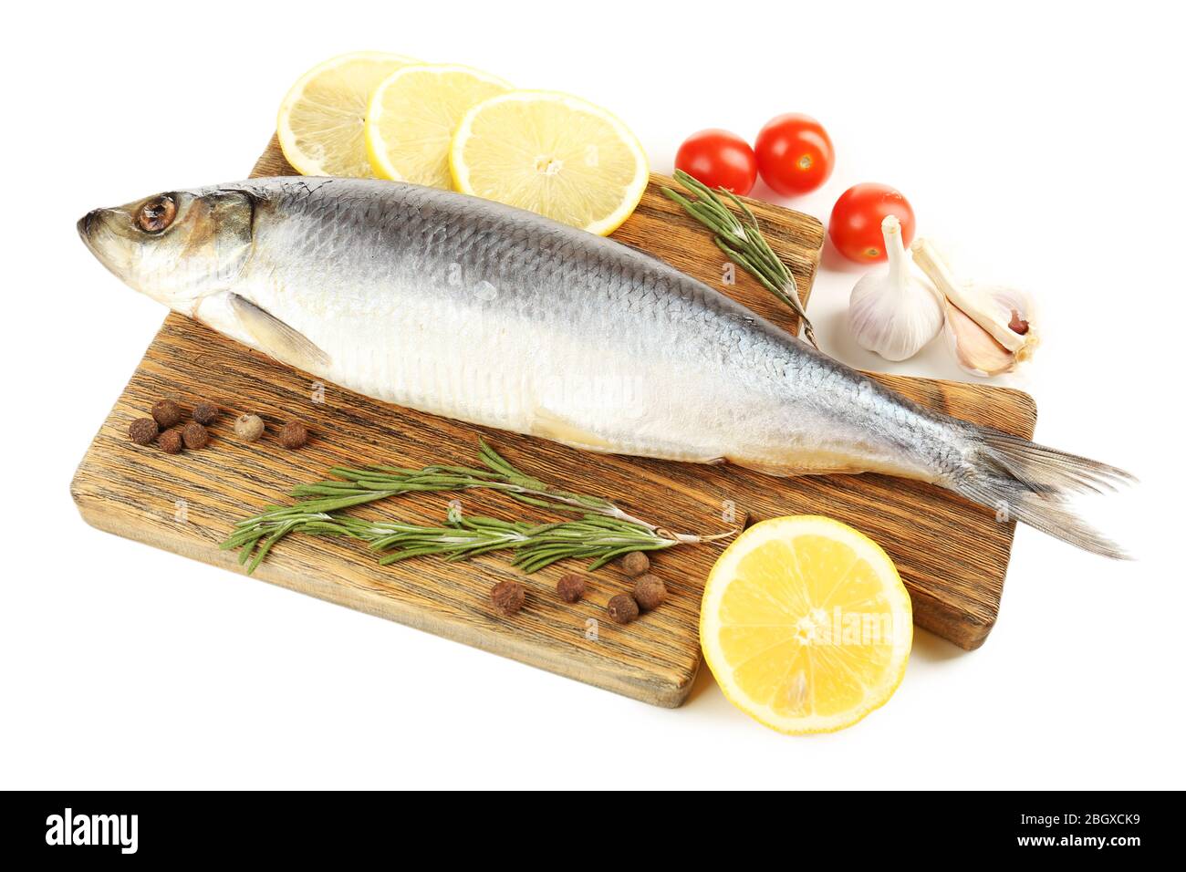 Fresh raw fish on cutting board and food ingredients isolated on white ...