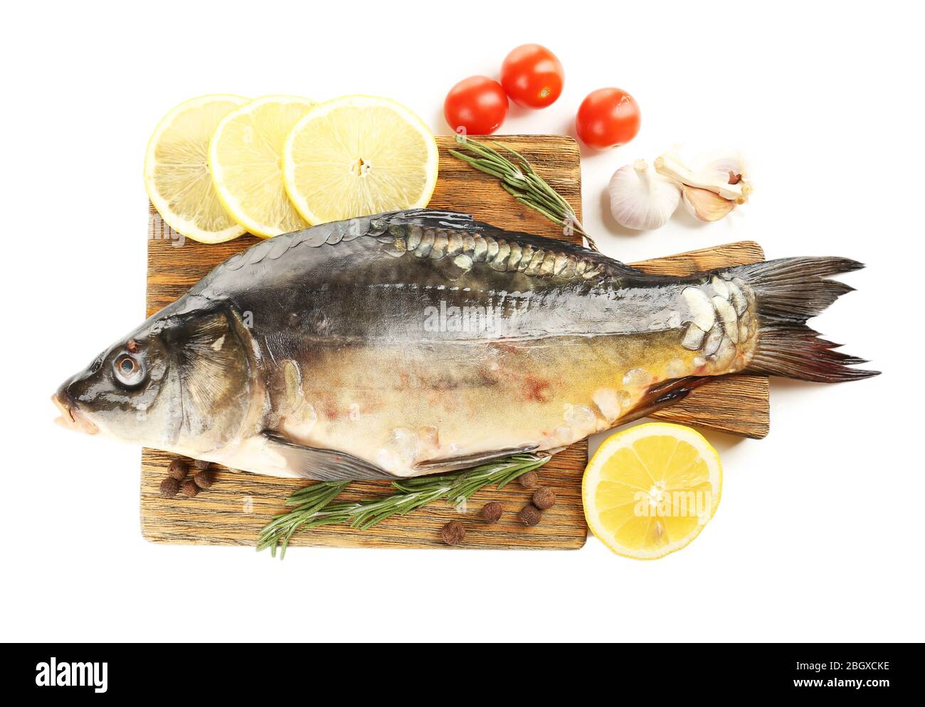 Fresh raw fish on cutting board and food ingredients isolated on white ...