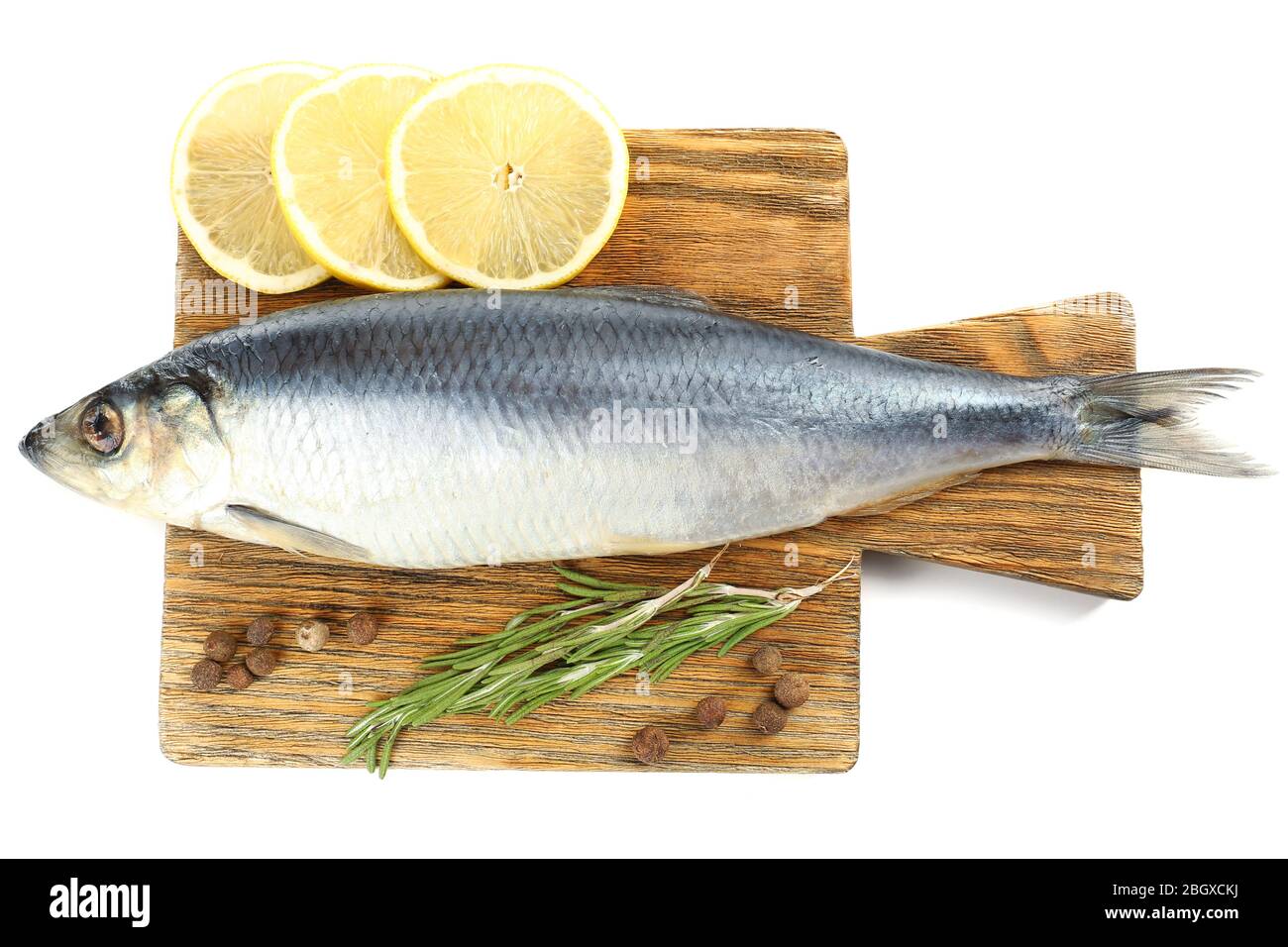 Fresh raw fish on cutting board and food ingredients isolated on white ...