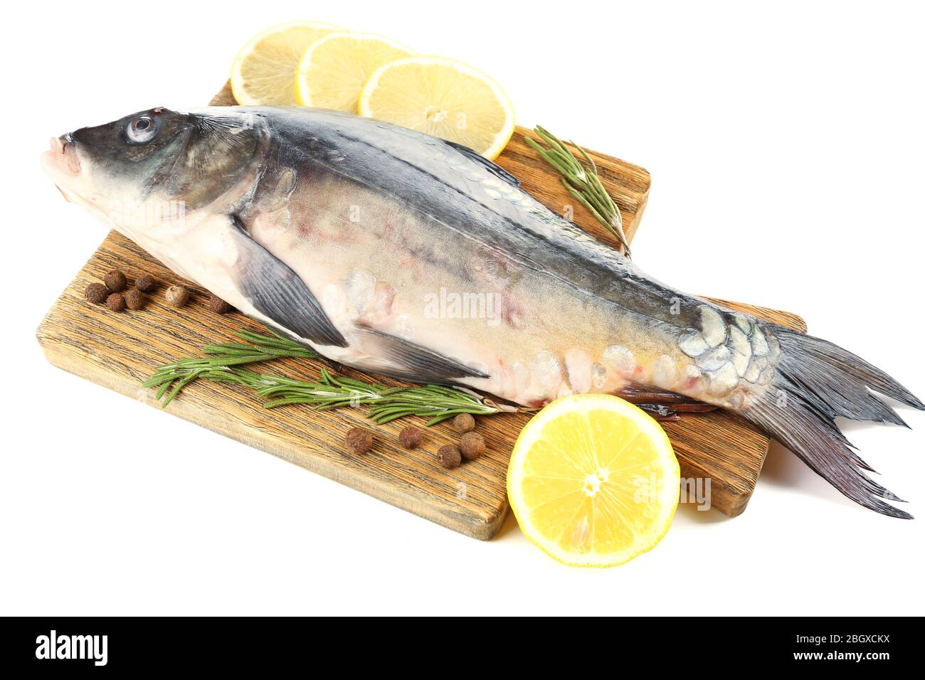 Fresh raw fish on cutting board and food ingredients isolated on white ...