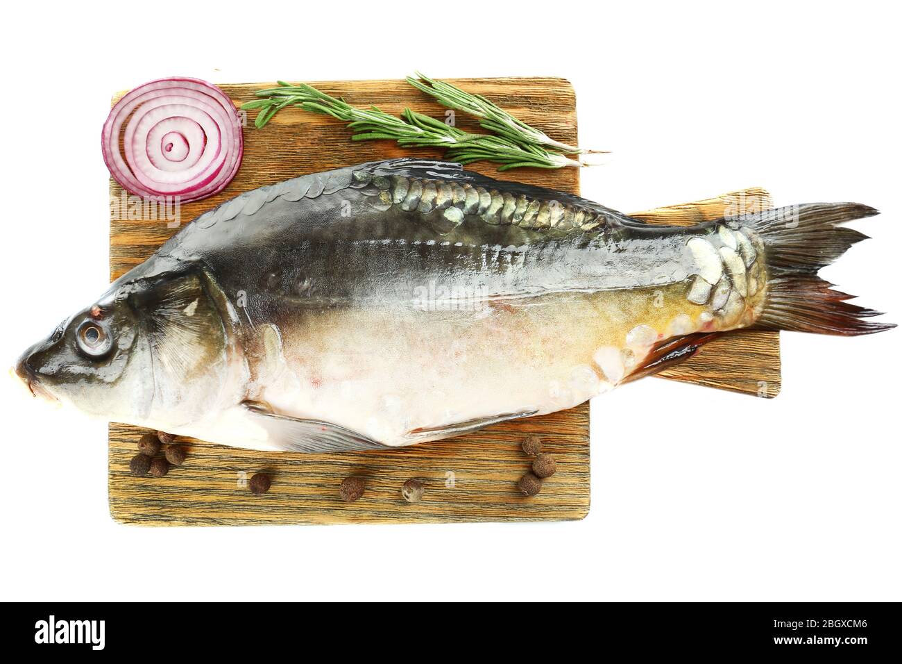 Fresh raw fish on cutting board and food ingredients isolated on white ...