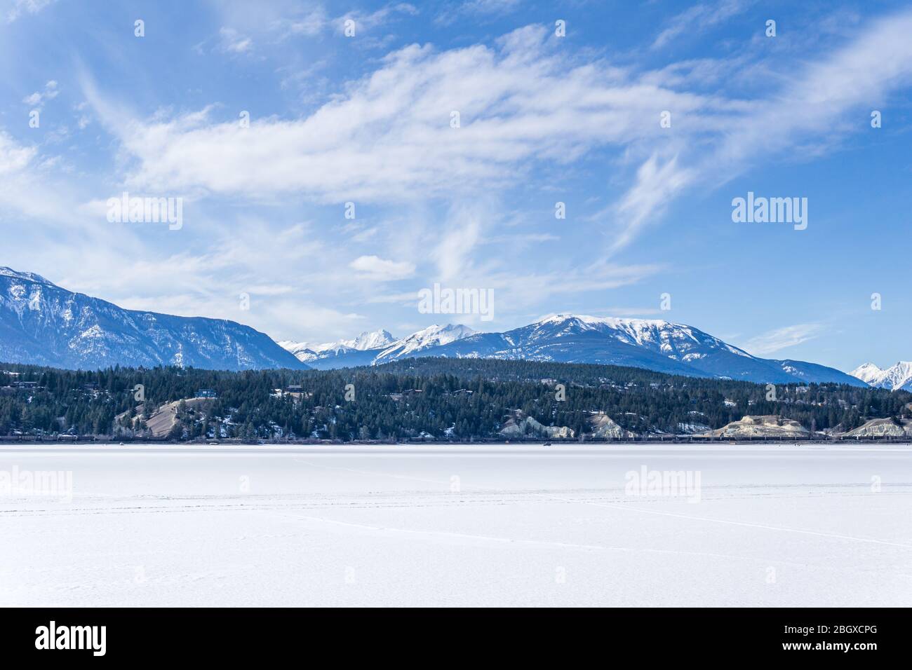 frozen Windermere lake and rocky mountains in british columbia canada ...