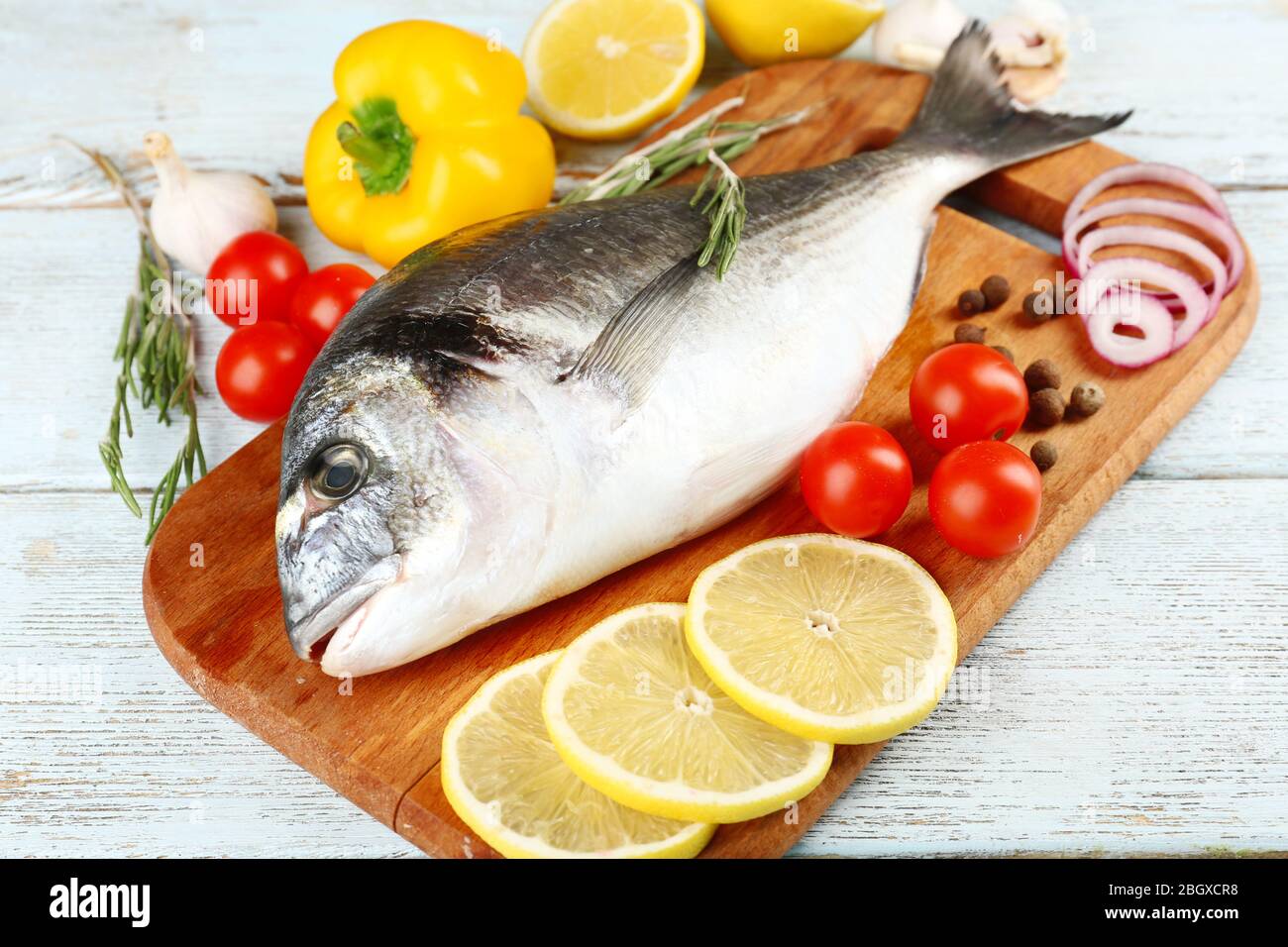 Fresh raw fish and food ingredients on table Stock Photo - Alamy