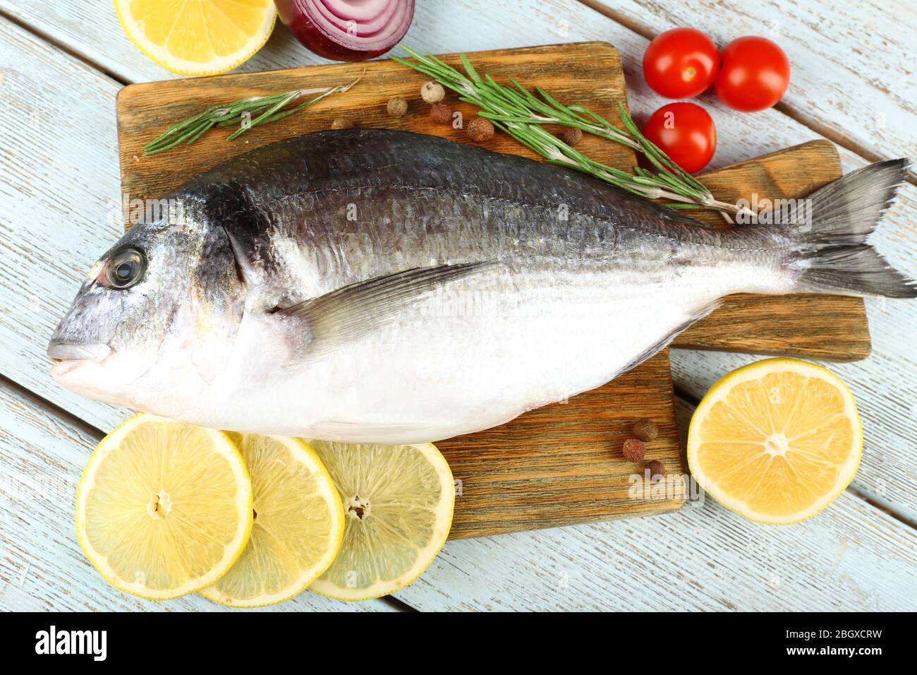 Fresh raw fish and food ingredients on table Stock Photo - Alamy