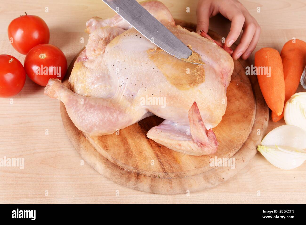 Woman preparing chicken, close-up Stock Photo - Alamy