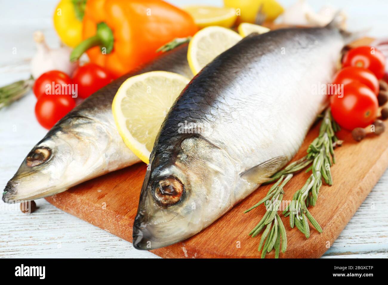 Fresh raw fish and food ingredients on table Stock Photo - Alamy