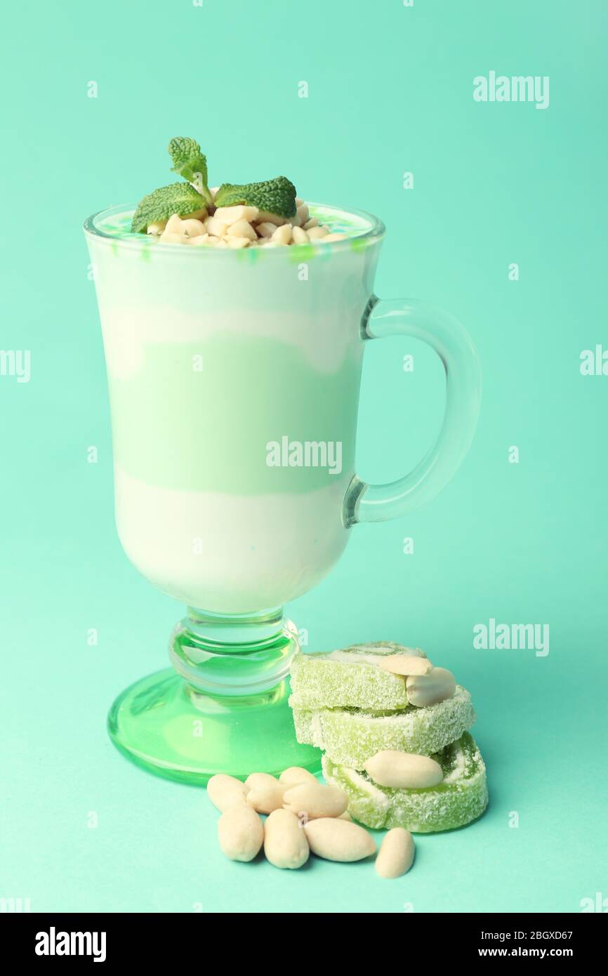 Mint milk dessert with nuts in glass on color background Stock Photo ...