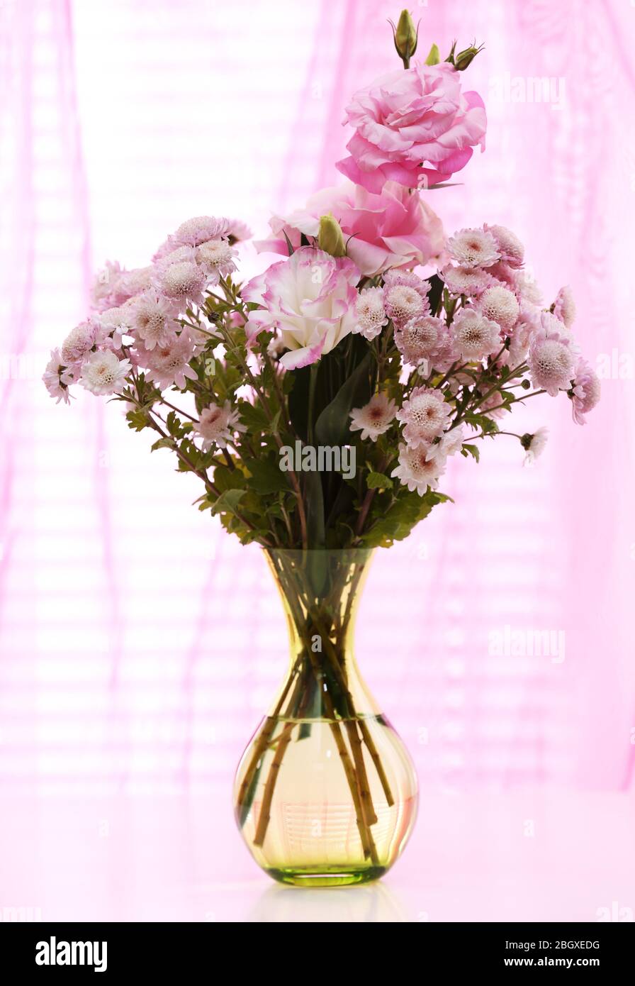Beautiful flowers in vase with light from window Stock Photo - Alamy