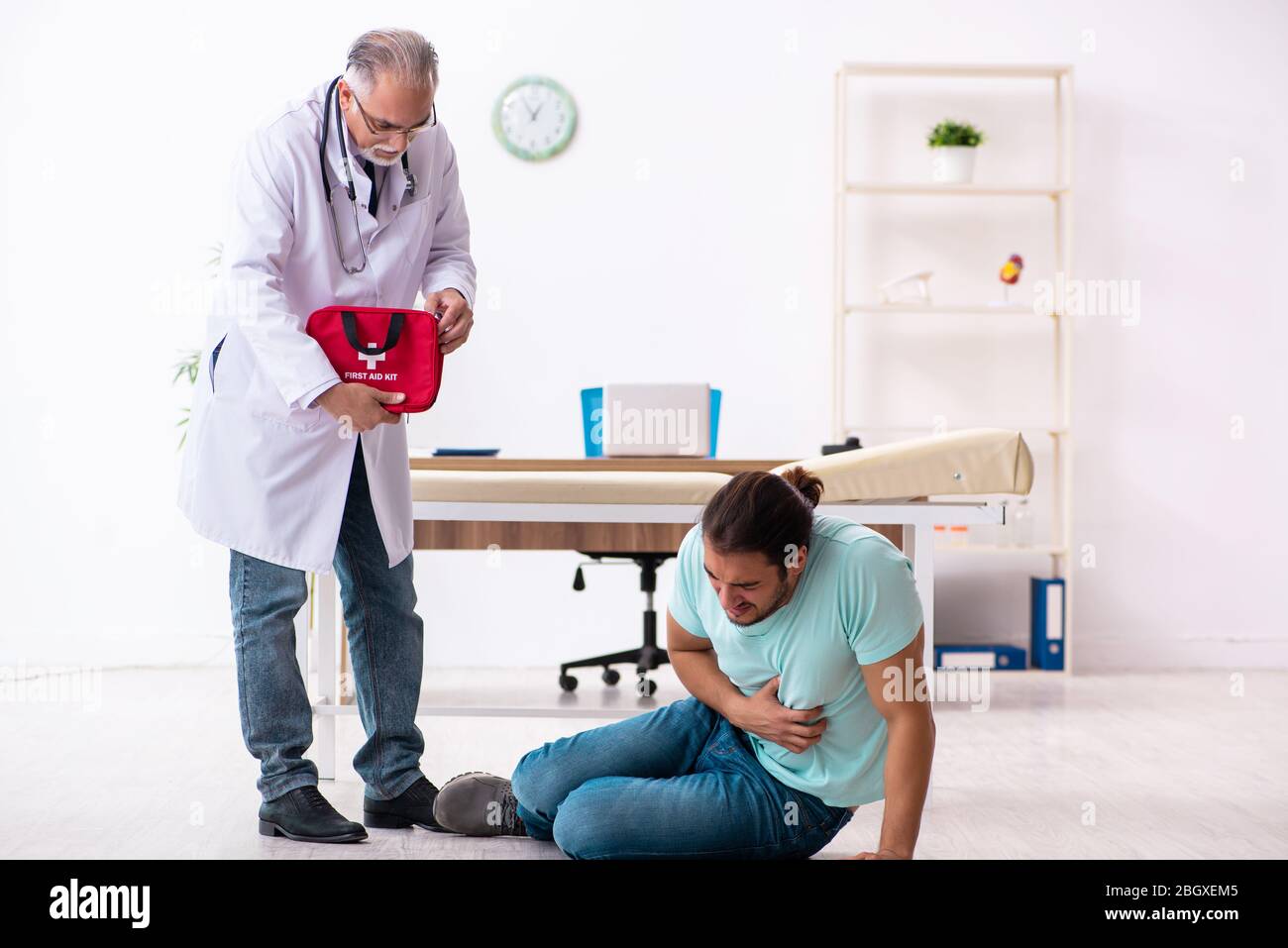 Experienced doctor and male patient in first aid concept Stock Photo ...