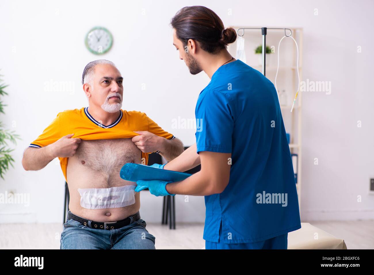 Old man visiting male doctor Stock Photo - Alamy