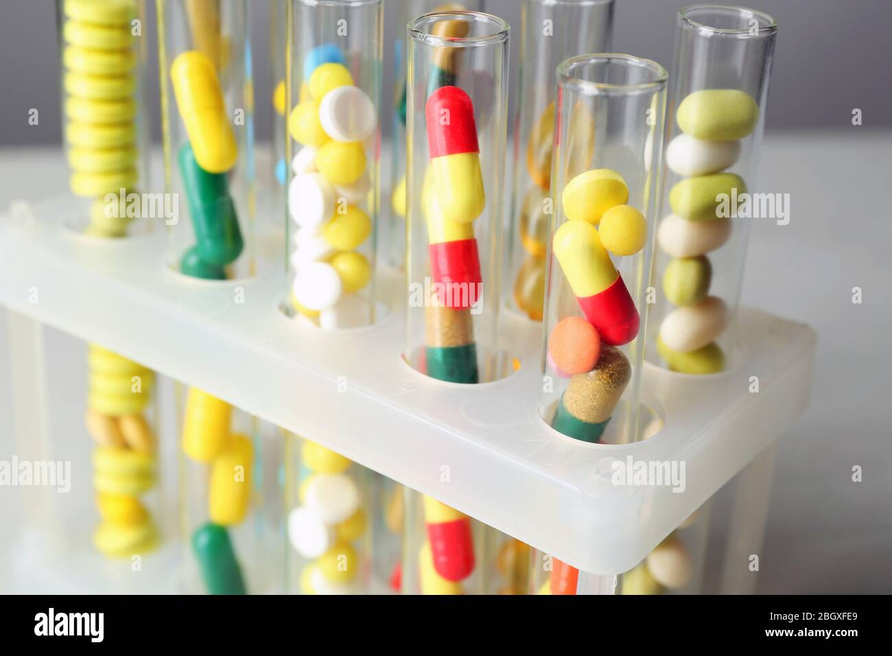 Different color drugs in test tubes, on wooden table background Stock ...