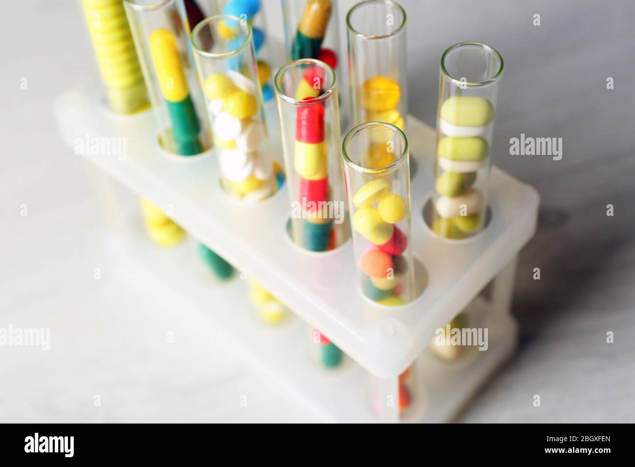 Different color drugs in test tubes, on wooden table background Stock ...