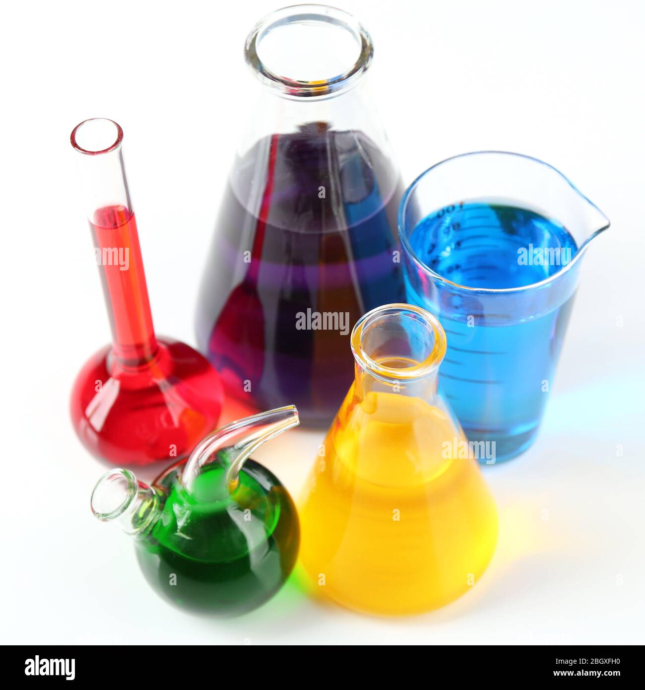Different laboratory glassware with colorful liquid isolated on white ...