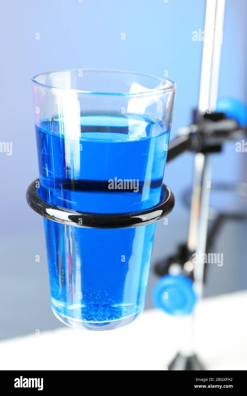 Fixed glass on support on light blue background Stock Photo - Alamy