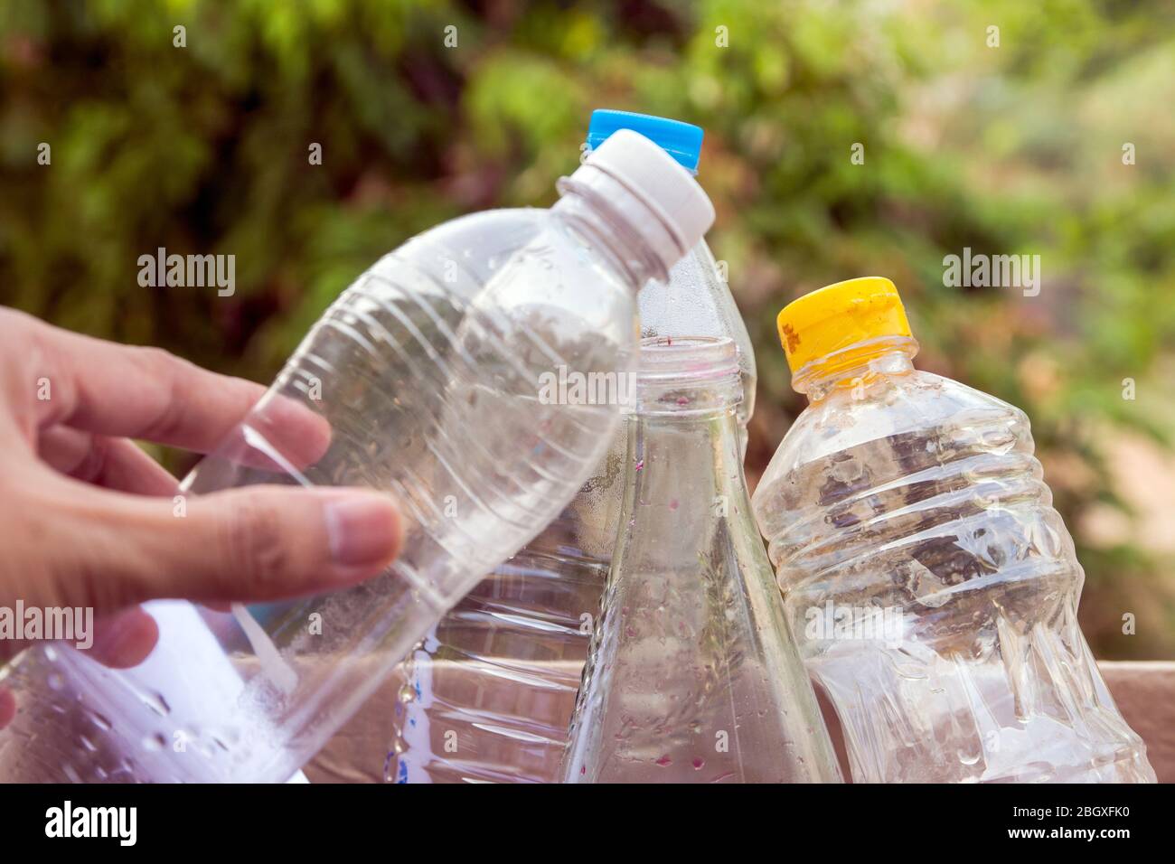 hand holding plastic recycle for cleaning Stock Photo - Alamy