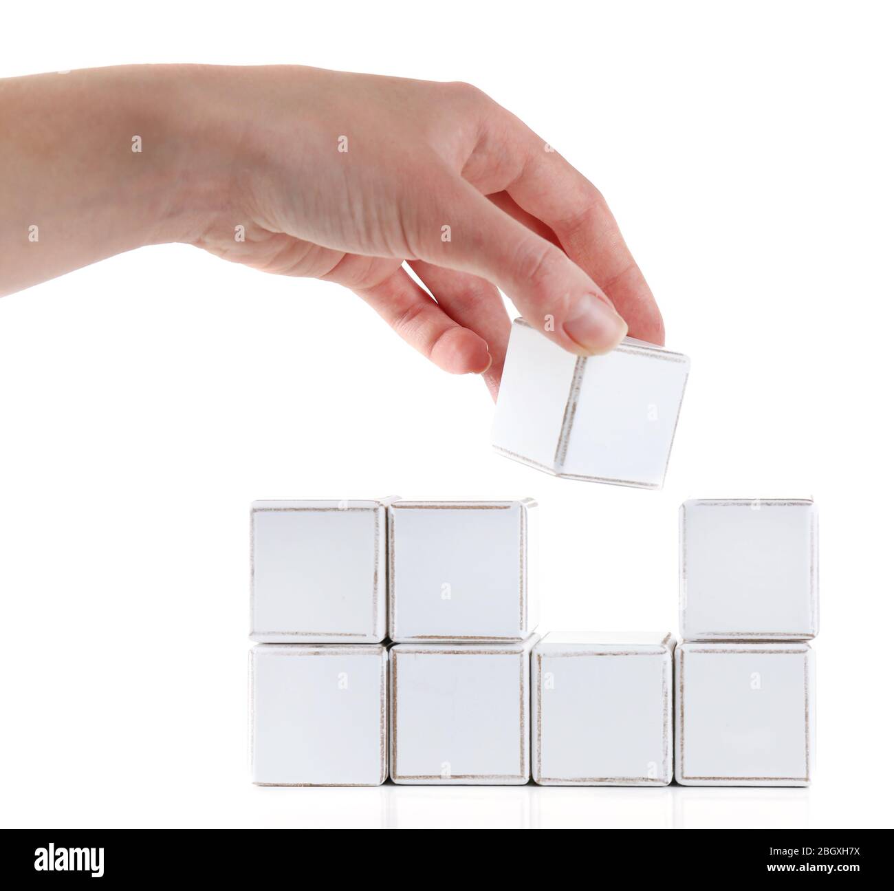 Educational cube in hand, isolated on white Stock Photo - Alamy
