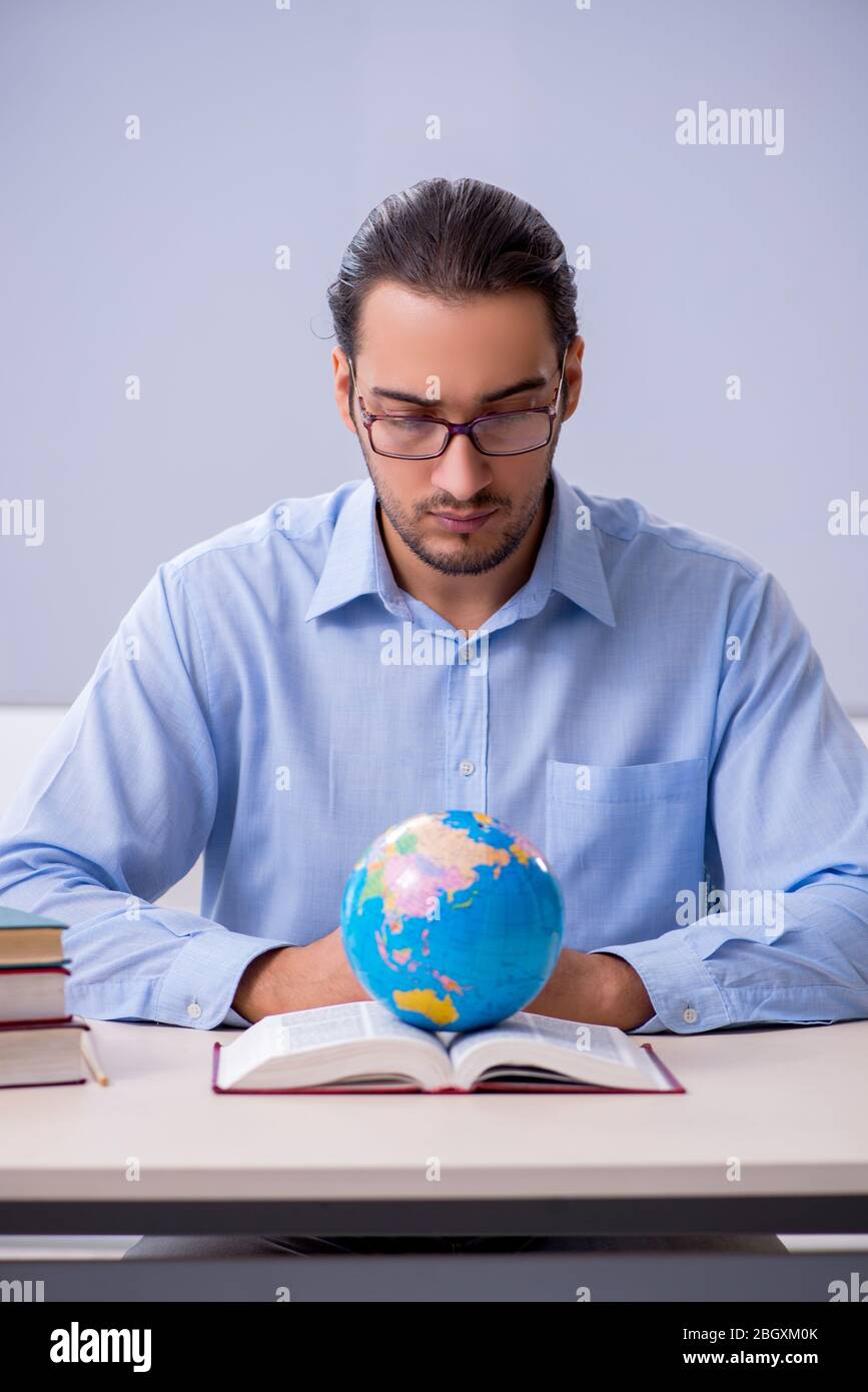 Young geography teacher in front of whiteboard Stock Photo - Alamy