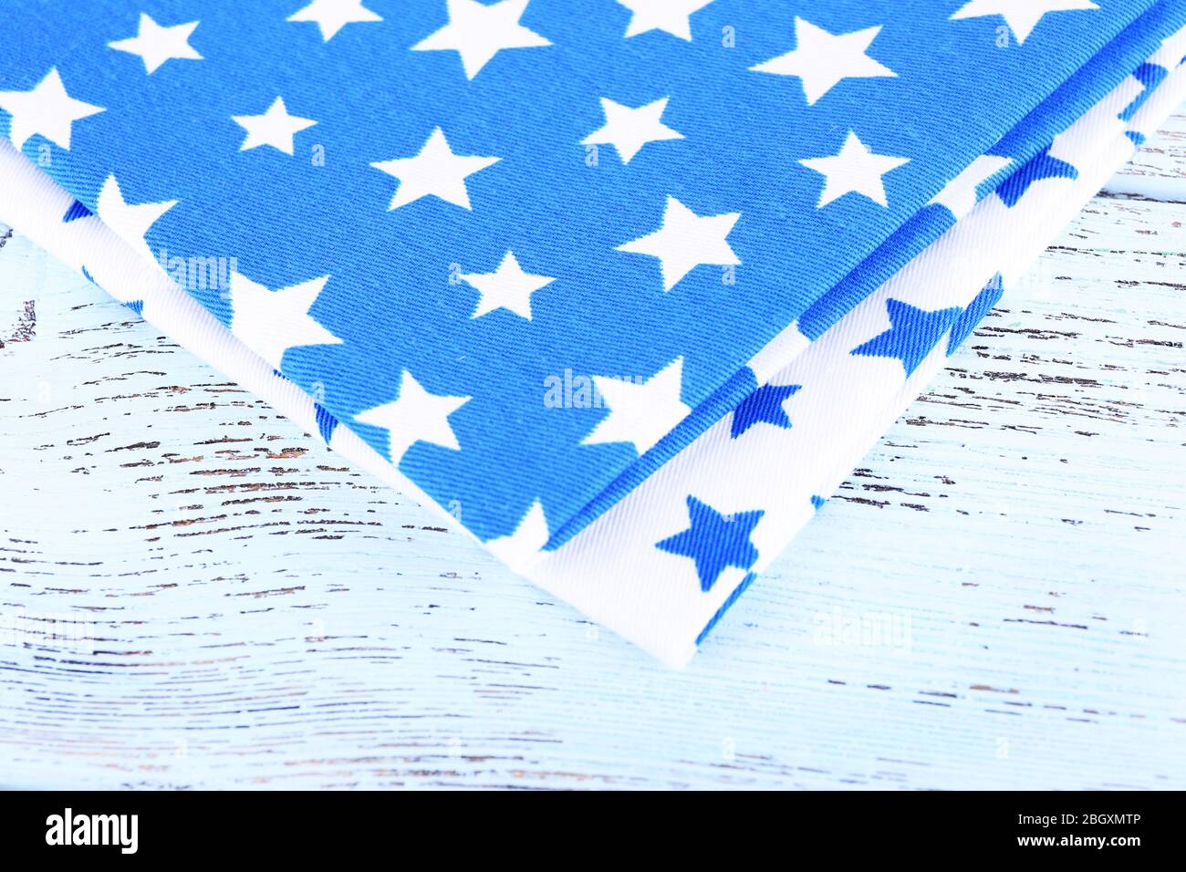 Blue napkins on wooden table Stock Photo - Alamy