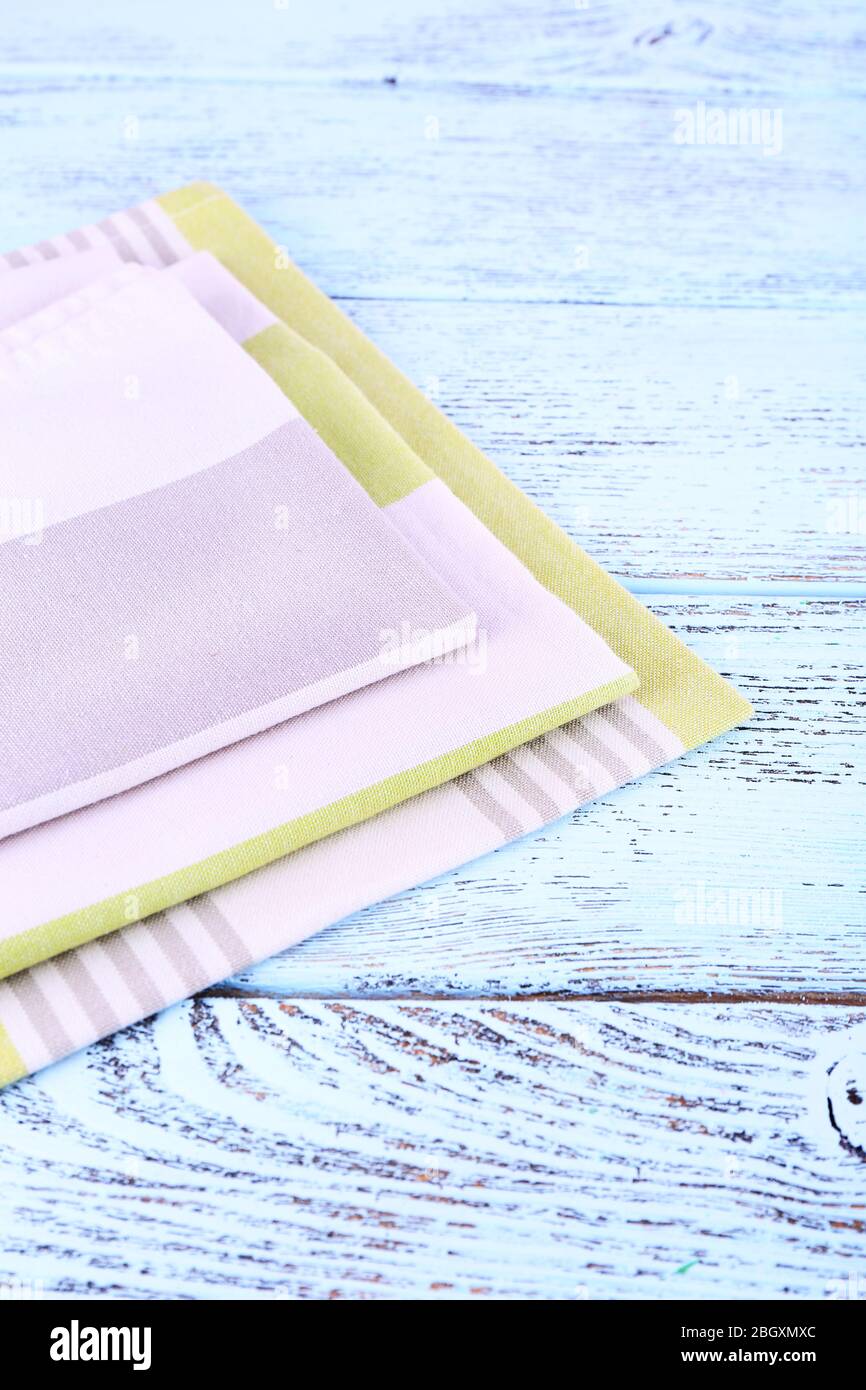 Colorful napkins on wooden table Stock Photo - Alamy