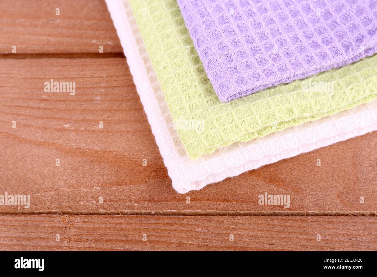 Colorful napkins on wooden table Stock Photo - Alamy