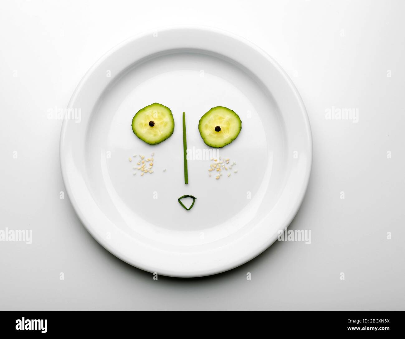 Vegetable face on plate isolated on white Stock Photo - Alamy
