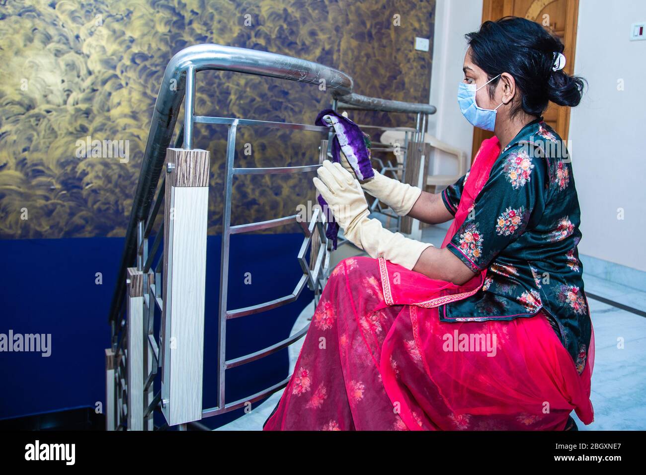 Coronavirus. Indian woman with face mask cleaning and disinfecting her ...