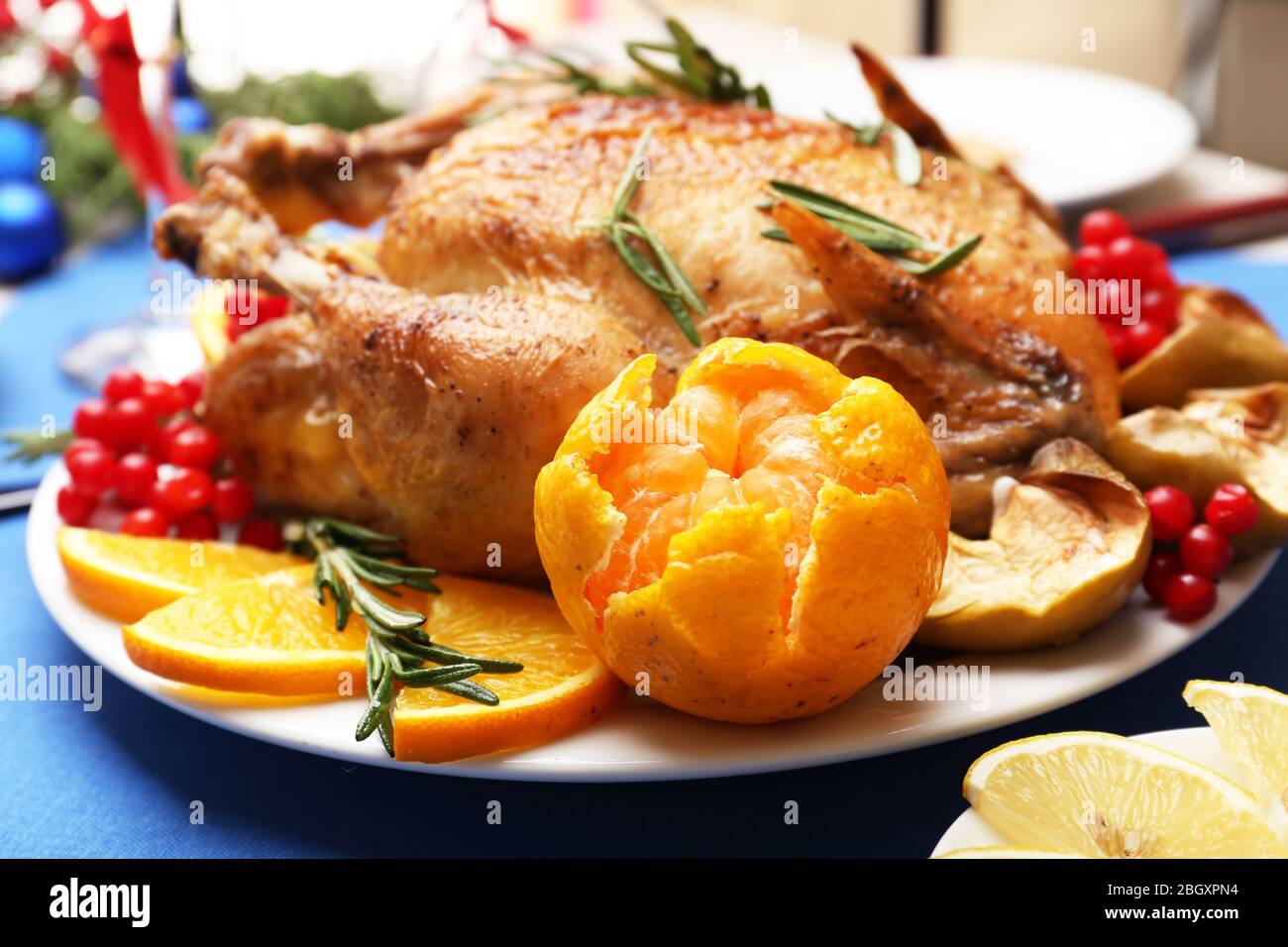 Baked chicken for festive dinner. Christmas table setting Stock Photo ...
