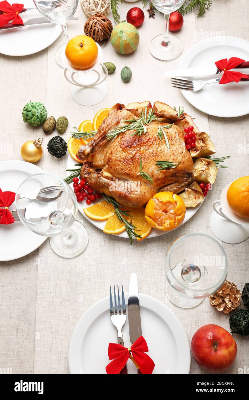Baked chicken for festive dinner. Christmas table setting Stock Photo ...