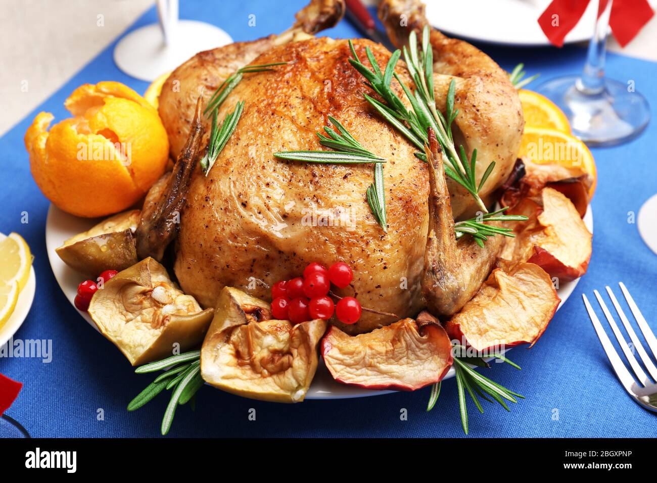 Baked chicken for festive dinner. Christmas table setting Stock Photo ...